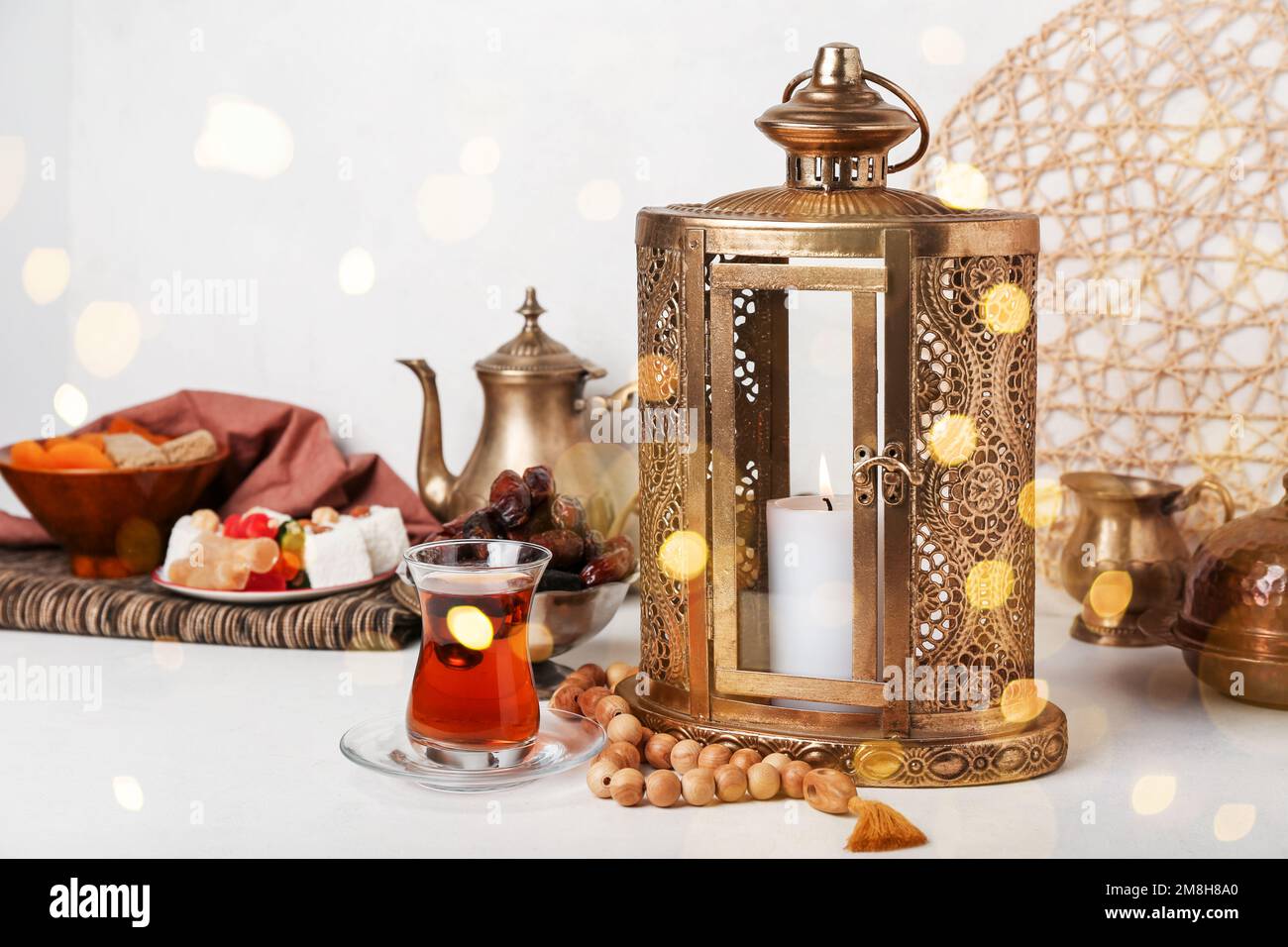Muslim lantern with tasbih and tea on light background. Ramadan ...