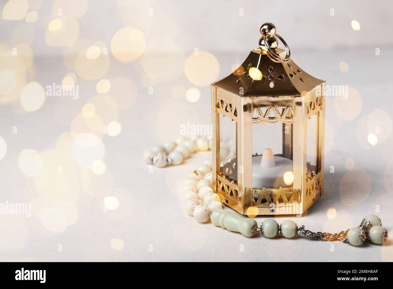 Muslim lantern with tasbih on light background with space for text ...