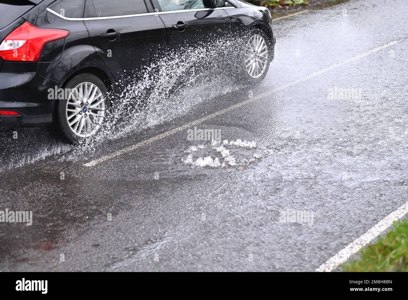 Car passing overflowing manhole cover hi-res stock photography and ...