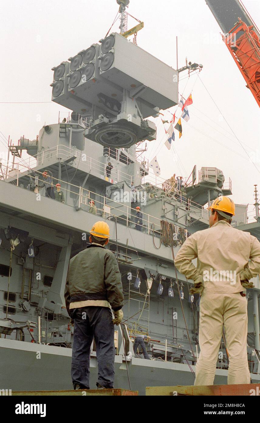 A Mark 25 Sea Sparrow basic point defense missile launcher is lowered ...