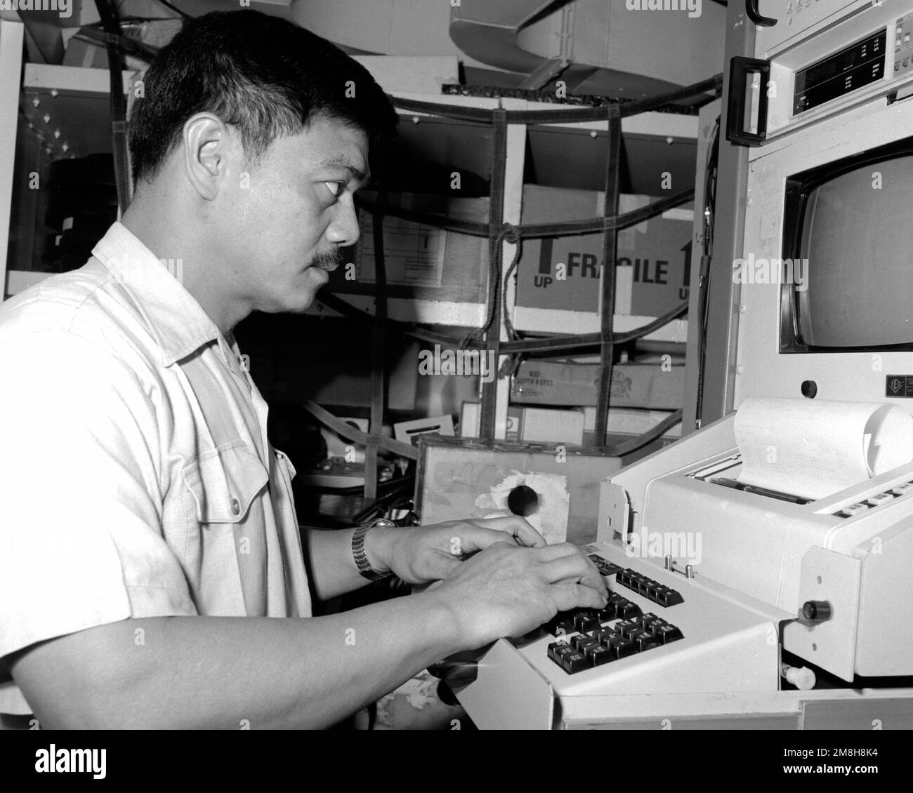 Aviation Electrician's Mate 2nd Class Siboma enters data into a ...