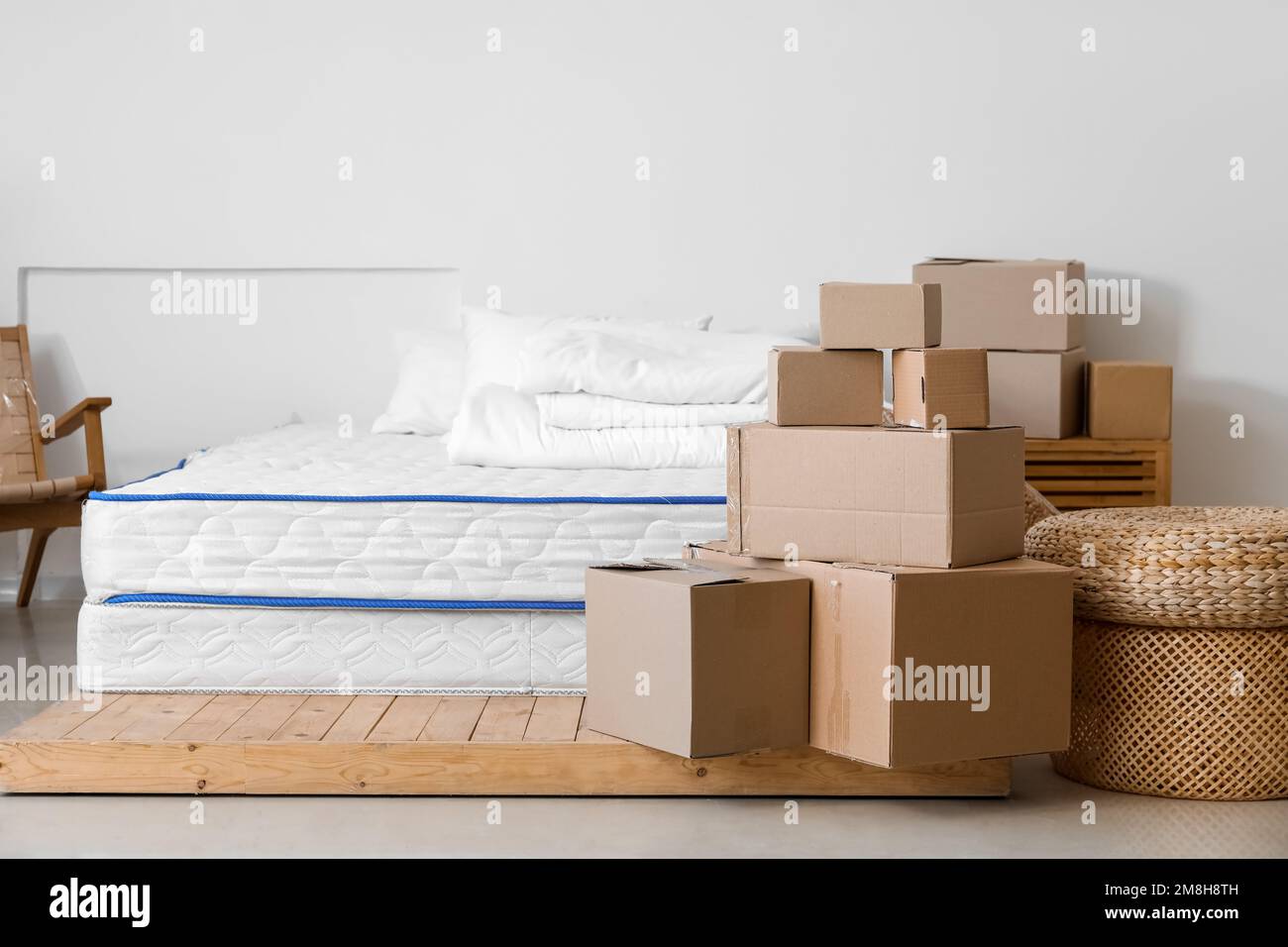 Cardboard boxes and bed in bedroom on moving day Stock Photo - Alamy