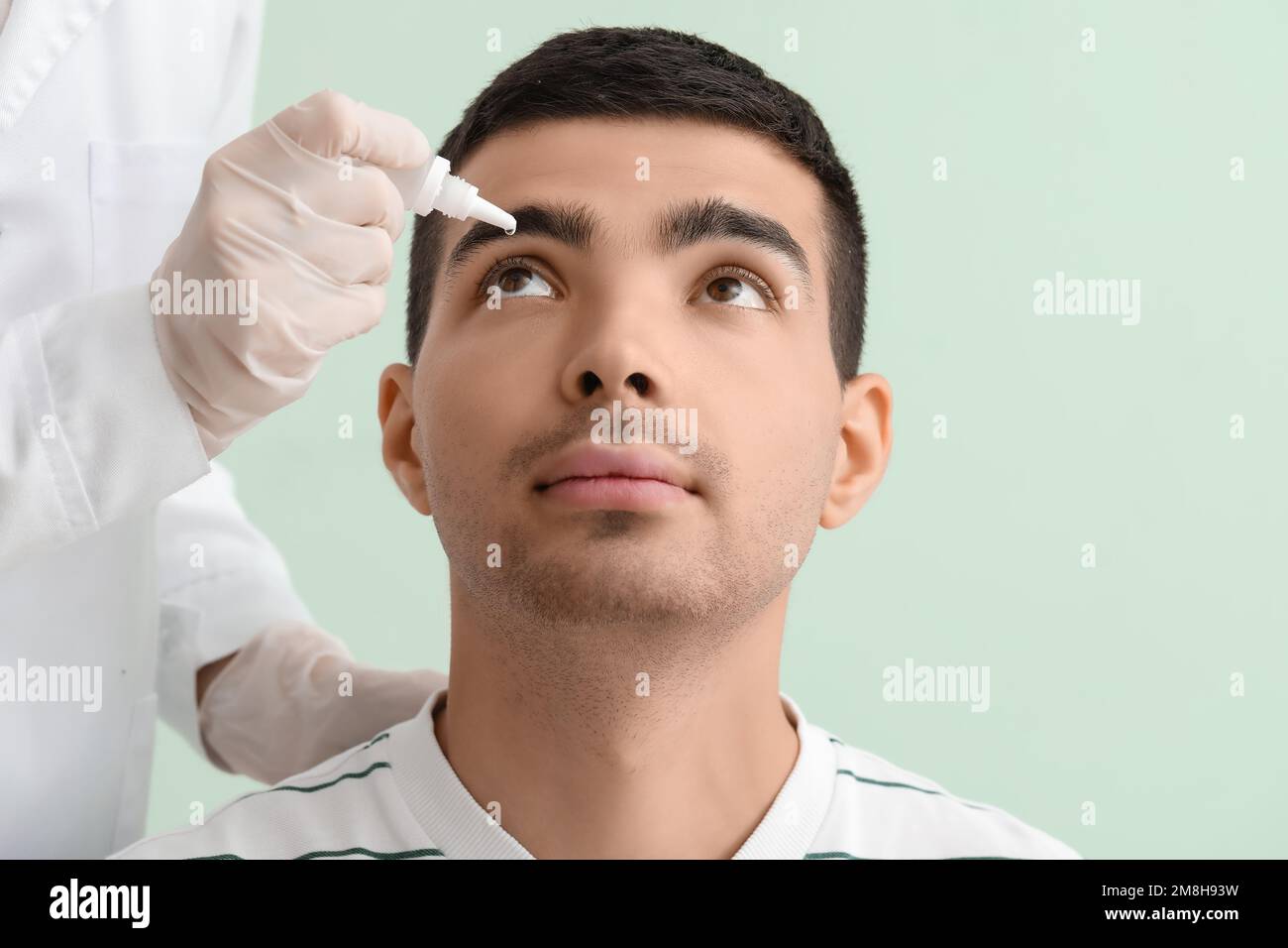 Man putting eye drops in his eyes hi-res stock photography and images ...
