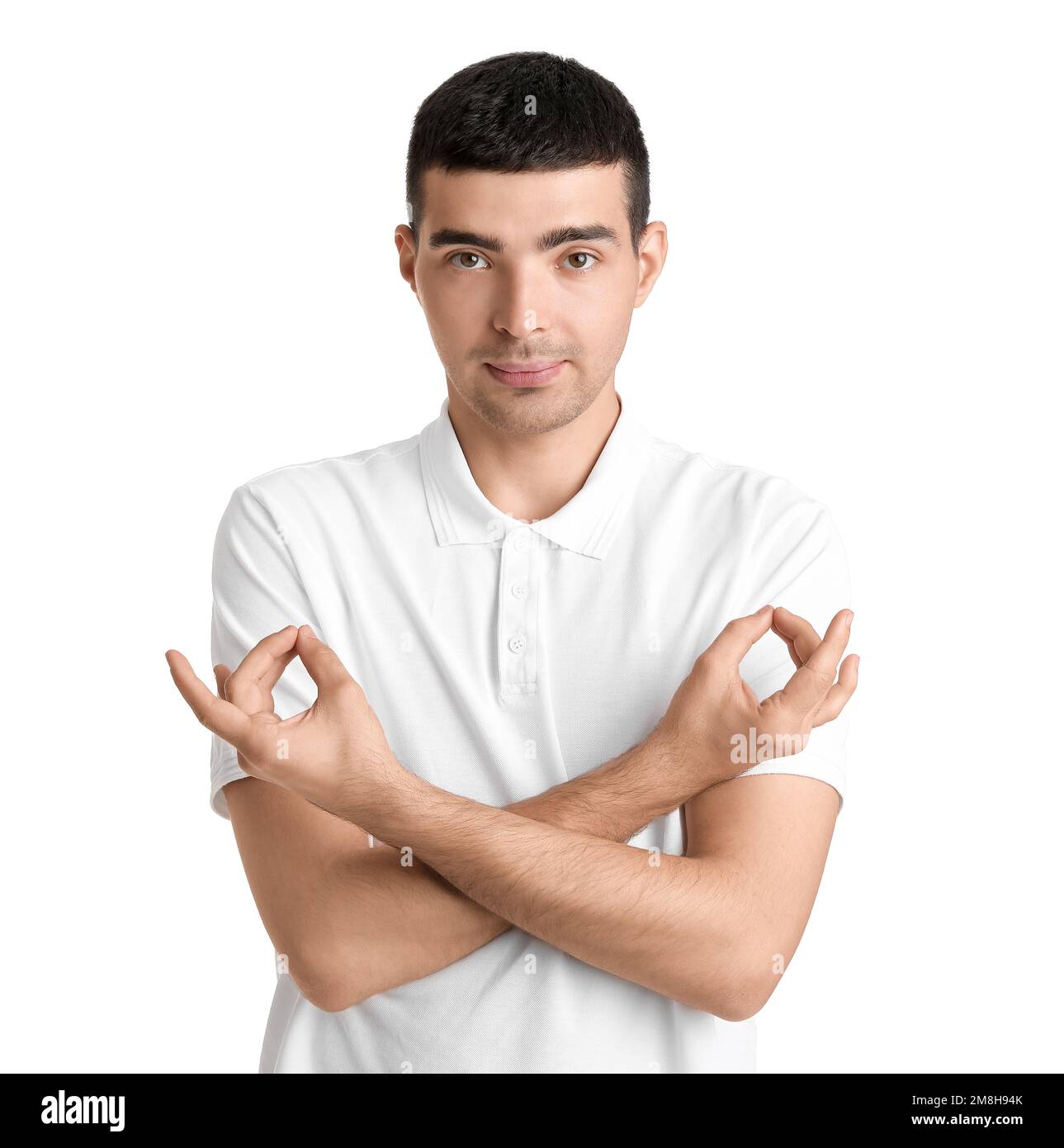 Young guy meditating on white background Stock Photo - Alamy