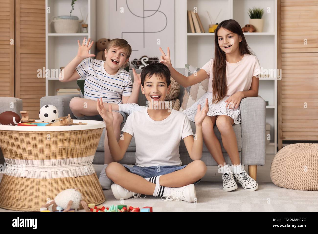 Happy little friends spending time together at home Stock Photo - Alamy