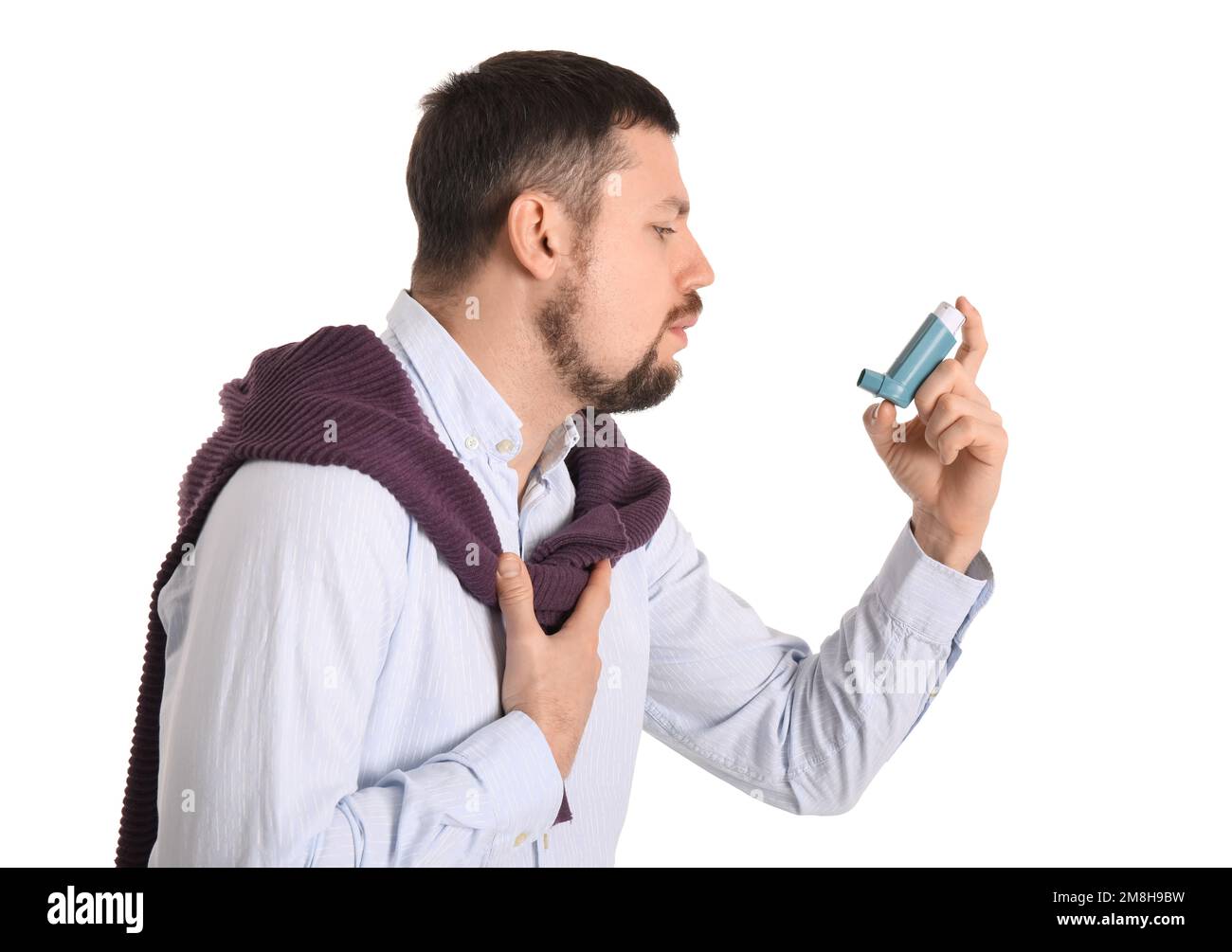 Sick man with inhaler on white background Stock Photo - Alamy