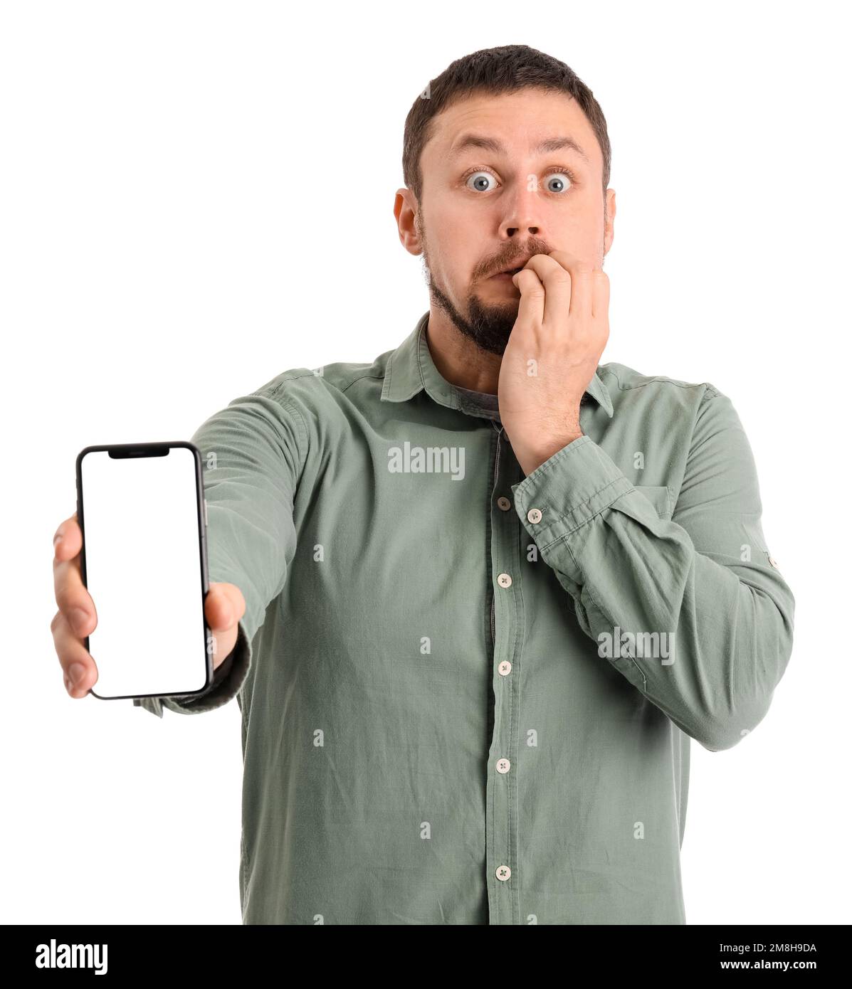 Handsome man with mobile phone biting nails on white background Stock ...