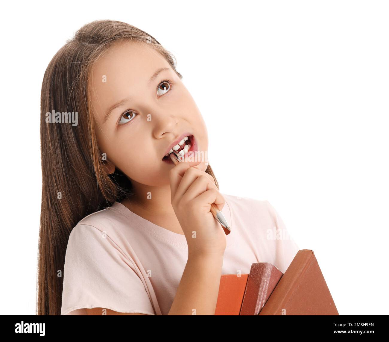 Little girl with books biting pen on white background, closeup Stock ...
