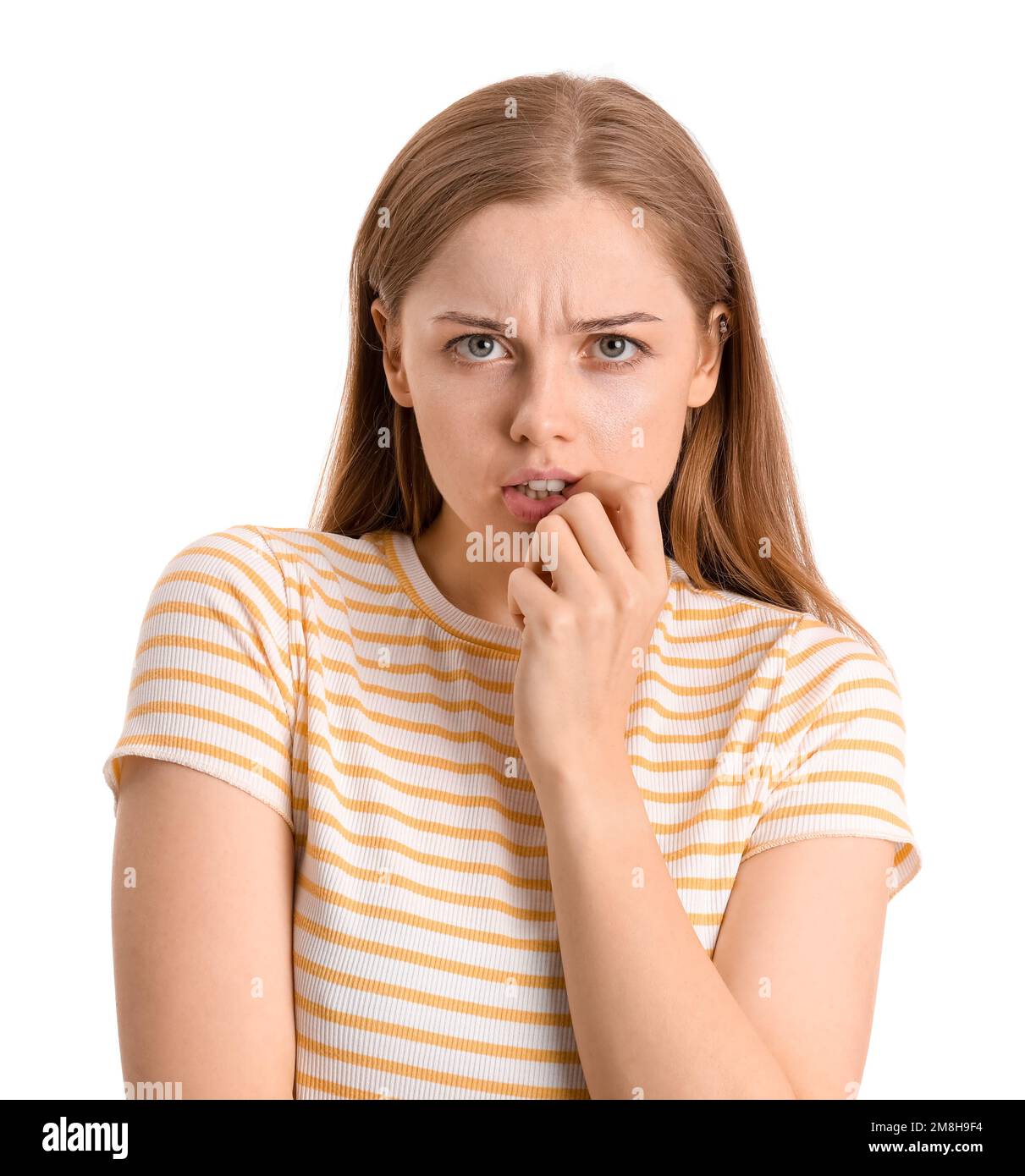 Young woman biting nails on white background Stock Photo - Alamy