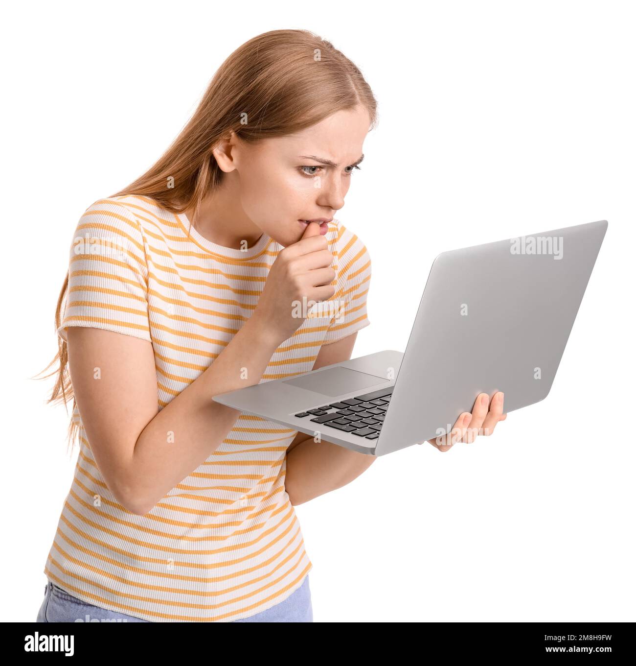 Young woman with laptop biting nails on white background Stock Photo ...