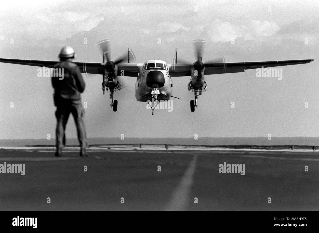 A flight deck crewman watches as a Fleet Logistic Support Squadron 40 ...