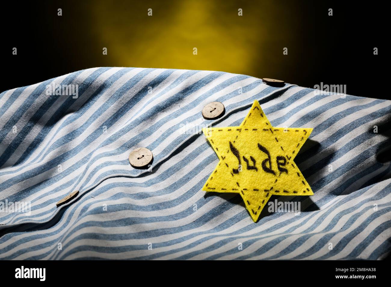 Prisoner uniform and Jewish badge on dark background, closeup ...