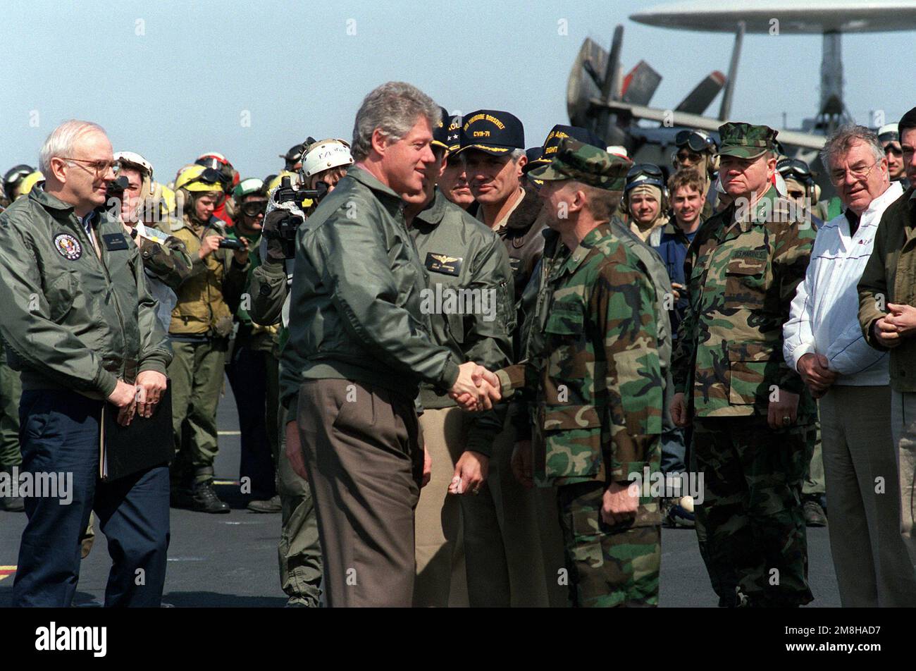 President William Jefferson Clinton shakes hands with a Marine officer ...