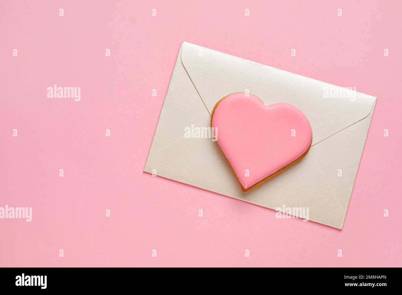 Envelope and heart shaped cookie on pink background. Valentines Day ...