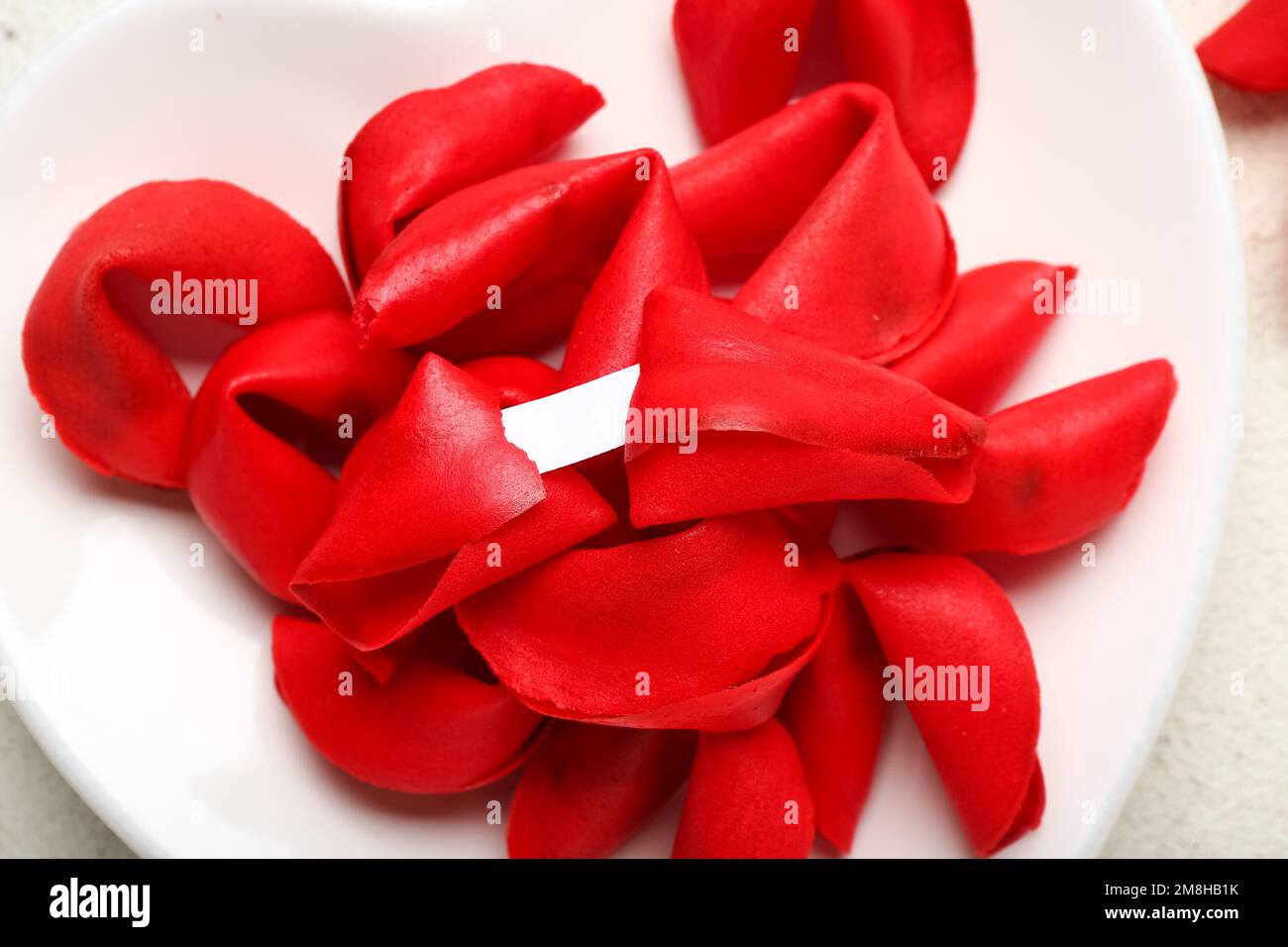 Plate with red fortune cookies on light background, closeup. Valentine ...