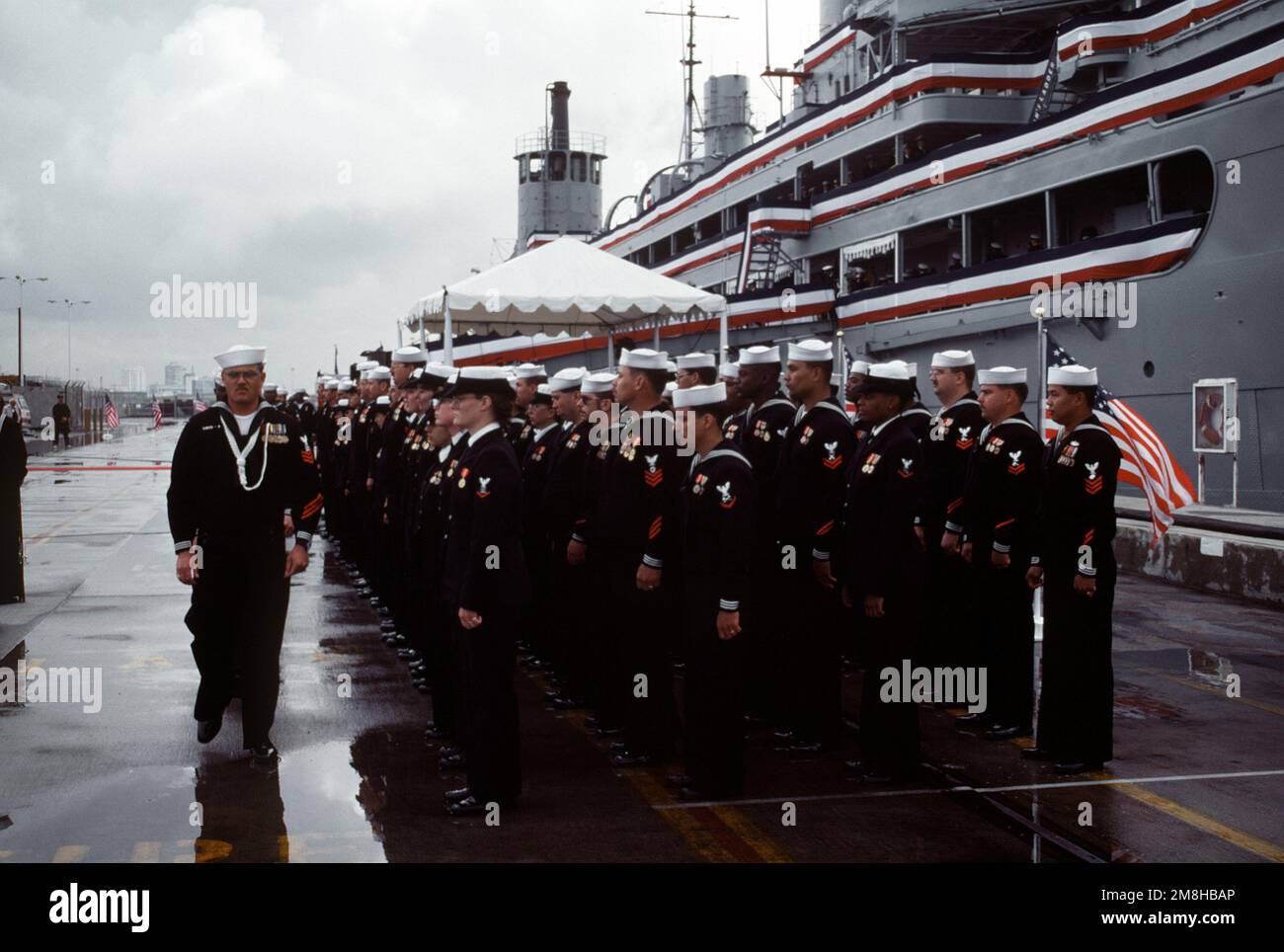Crew members stand in formation at the start of the decommissioning ...