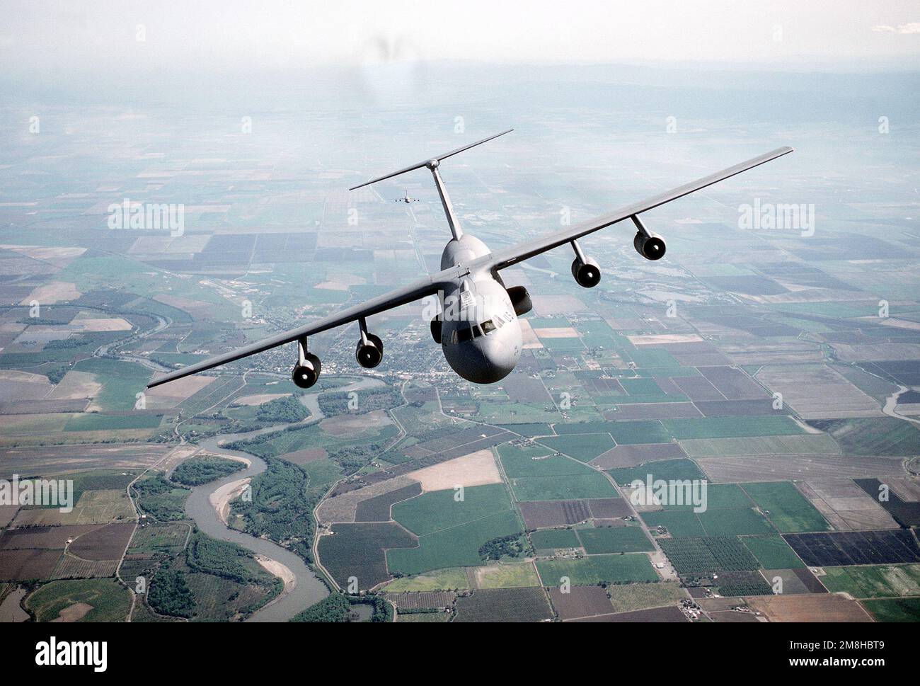 Air-to-air, high, front view of a 60th Airlift Wing C-141B Starlifter ...