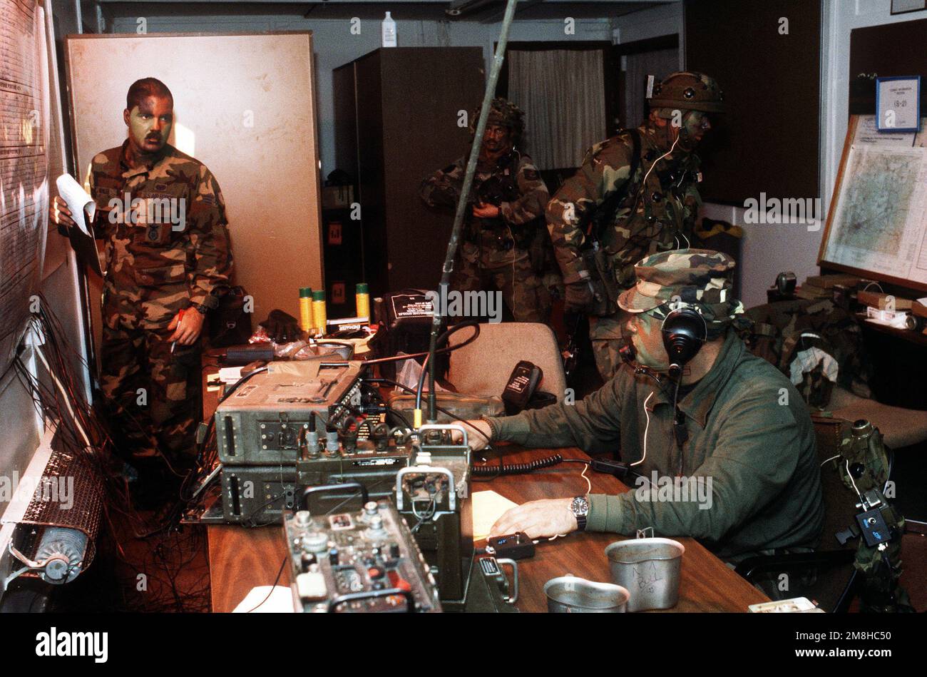 In a control room containing status boards and field telephones ...