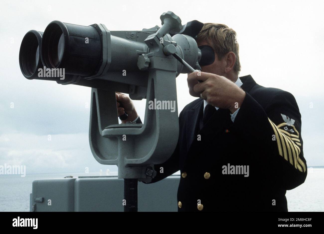 CHIEF Signalman Donald M. Tuttle looks through a pair of ship's ...