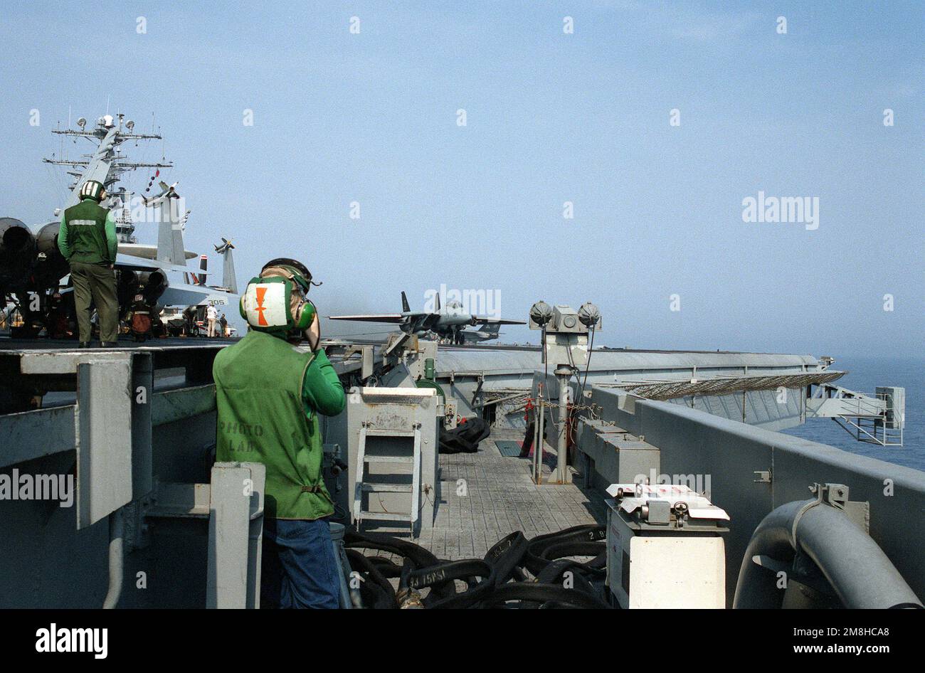 A photographer records a Fighter Squadron 84 (VF-84) F-14A Tomcat ...