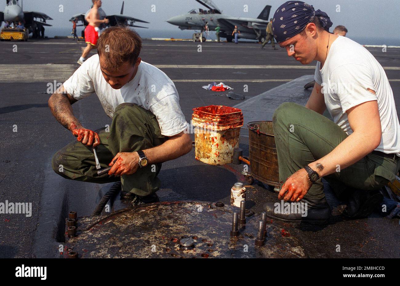 Aviation boatswain's mates service one of the retractable deck sheaves ...