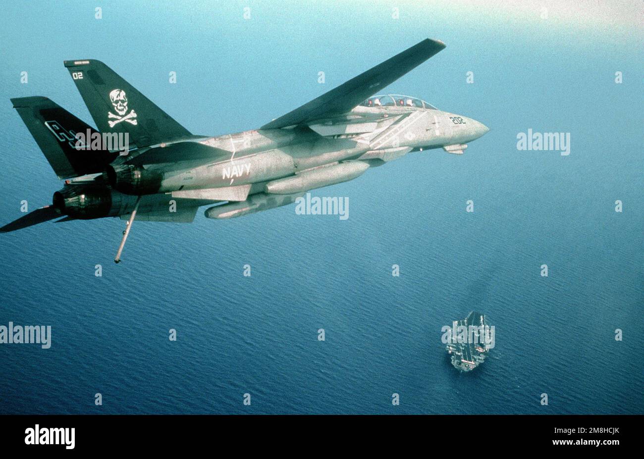 With tail hook down, a Fighter Squadron 84 (VF-84) F-14A Tomcat ...