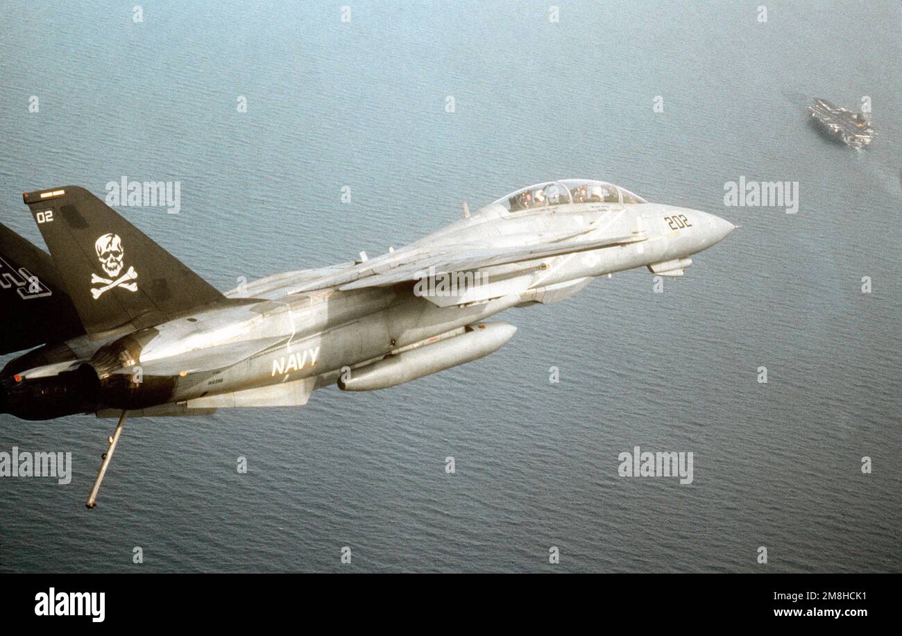 With tail hook down, a Fighter Squadron 84 (VF-84) F-14A Tomcat ...