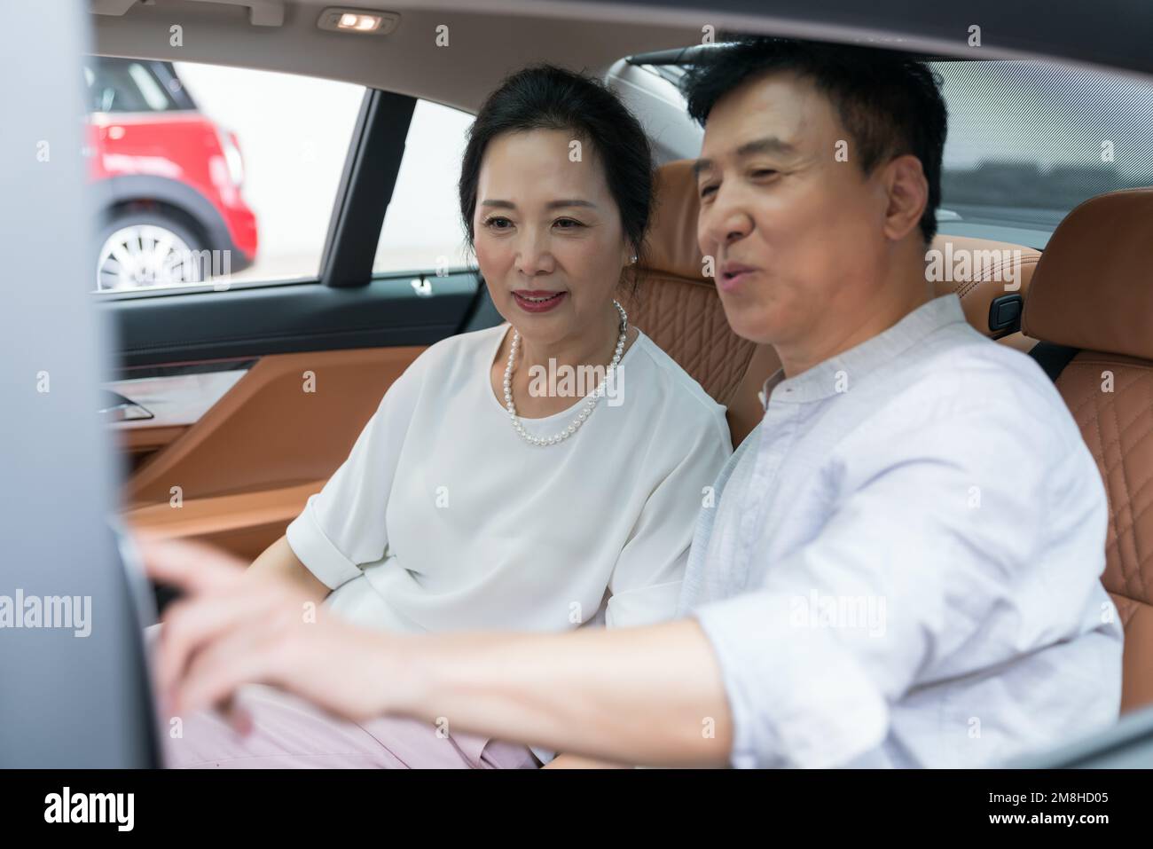 Elderly couples test drive cars Stock Photo - Alamy