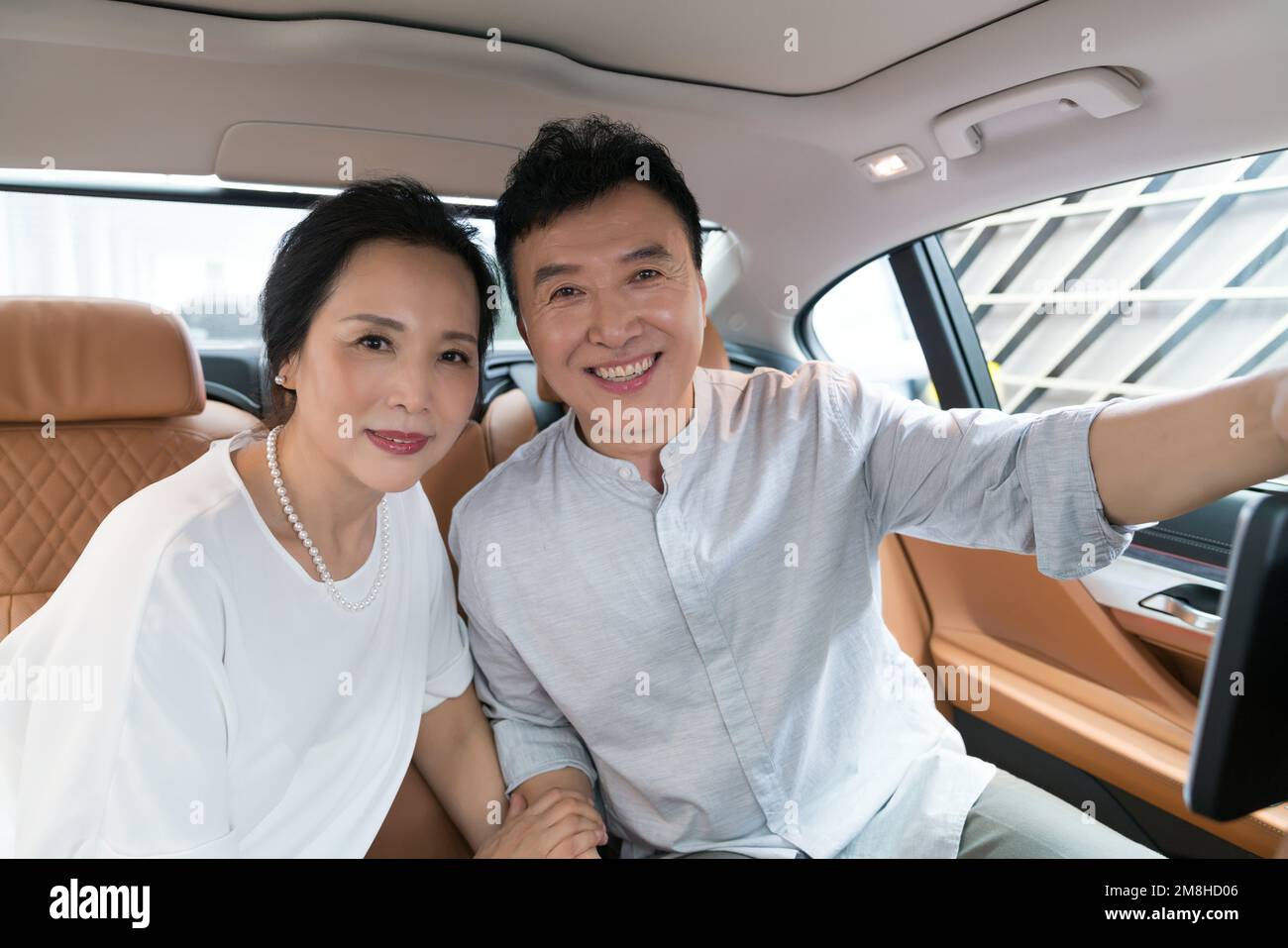 Elderly couples test drive cars Stock Photo - Alamy