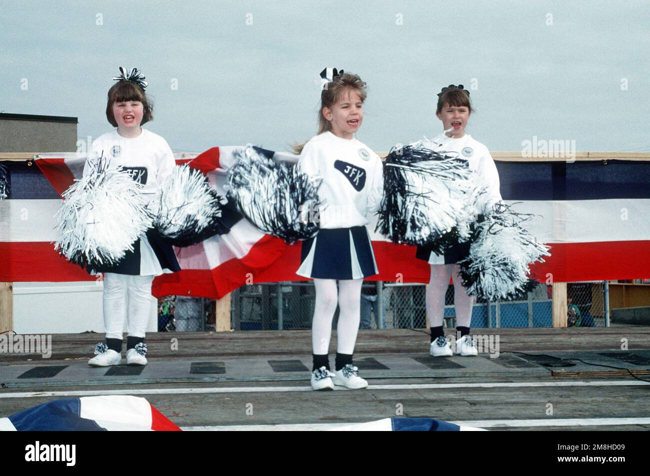 The JFK cheerleaders perform while waiting for their namesake, the ...