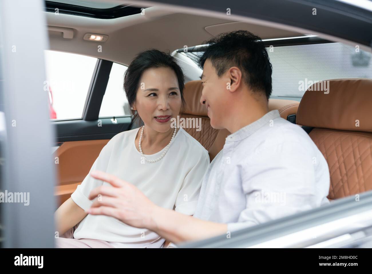 Elderly couples test drive cars Stock Photo - Alamy