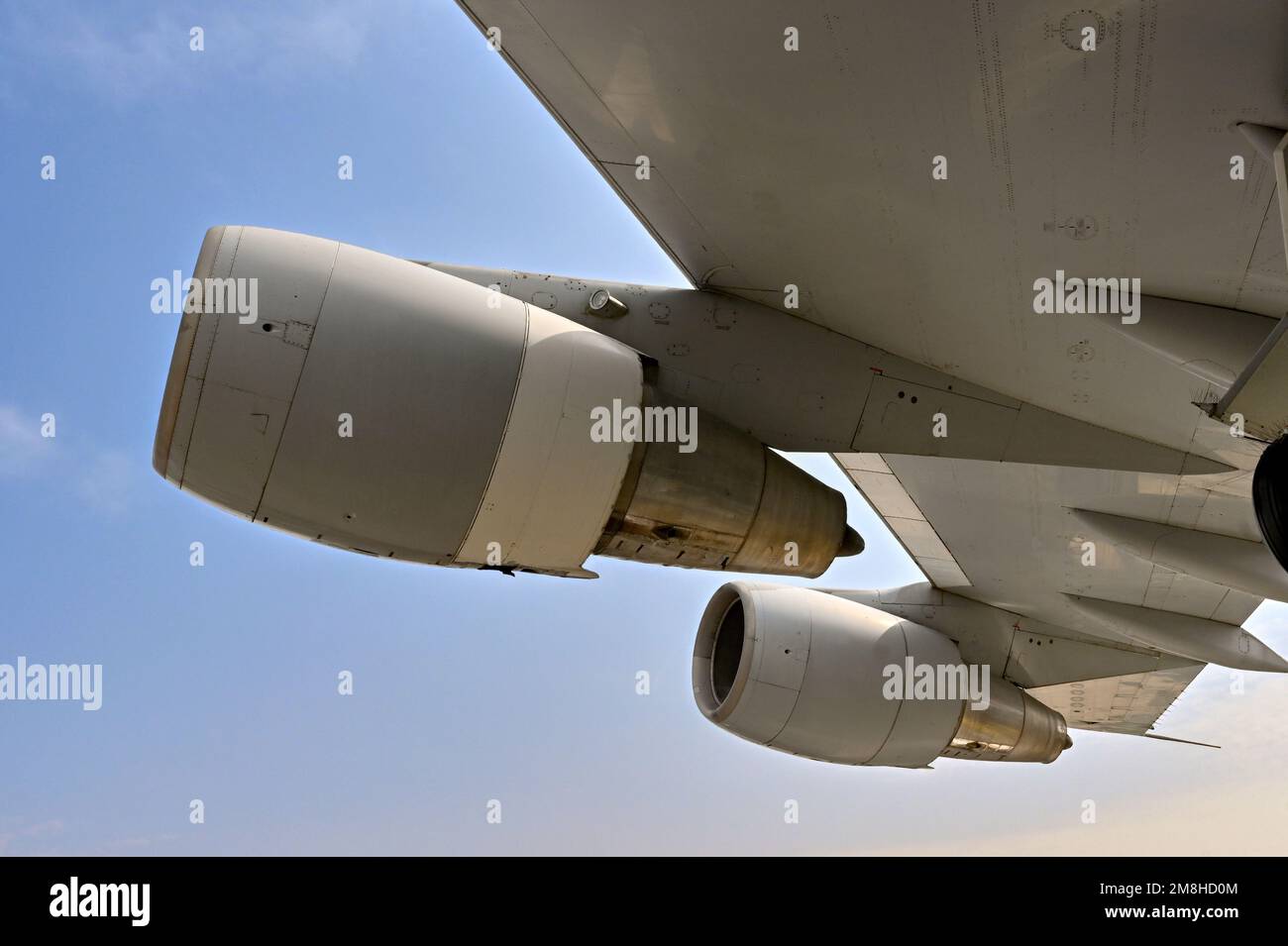 Engines of a large passenger jet in flight against a blue sky. No ...