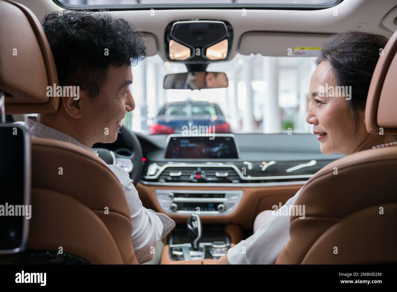 Elderly couples test drive cars Stock Photo - Alamy