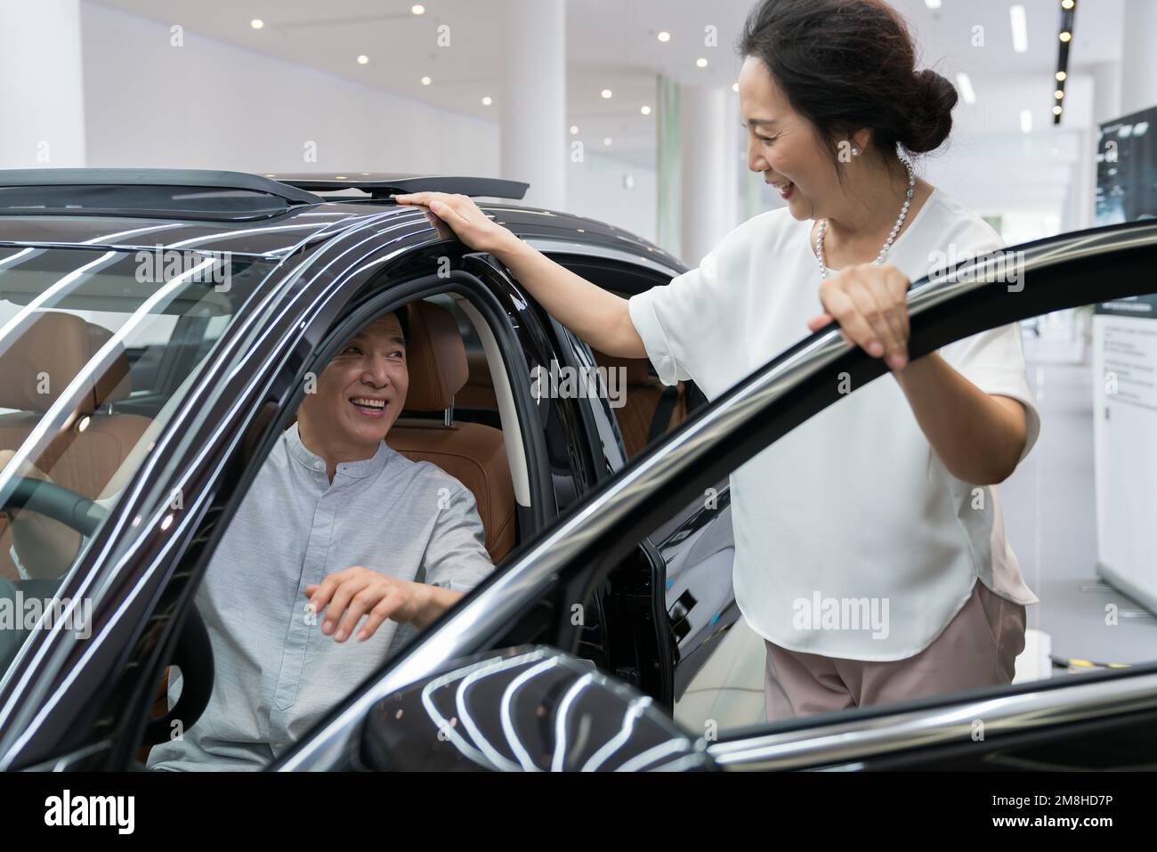 Elderly couples test drive cars Stock Photo - Alamy