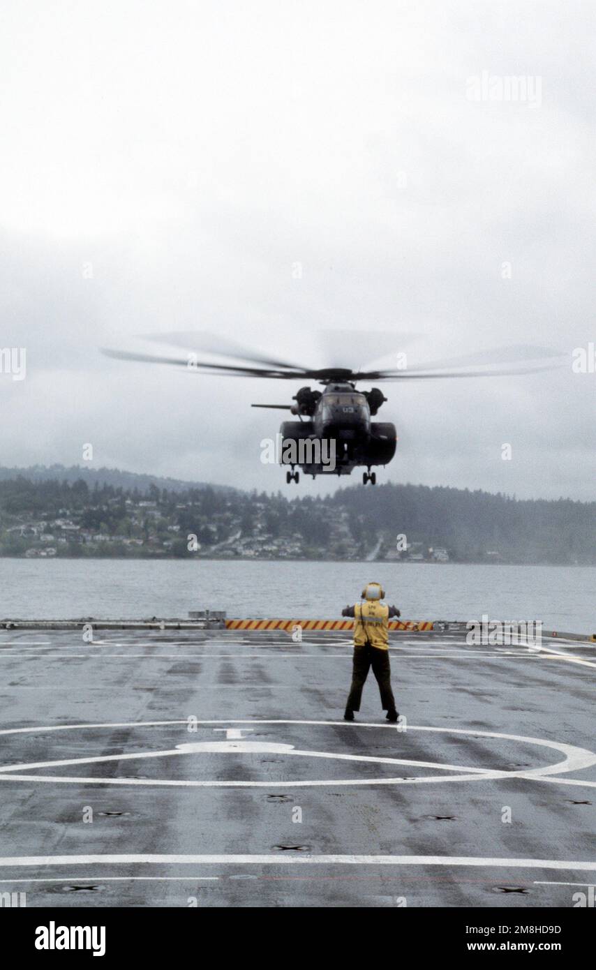 A plane director signals to the pilot of a Helicopter Mine ...