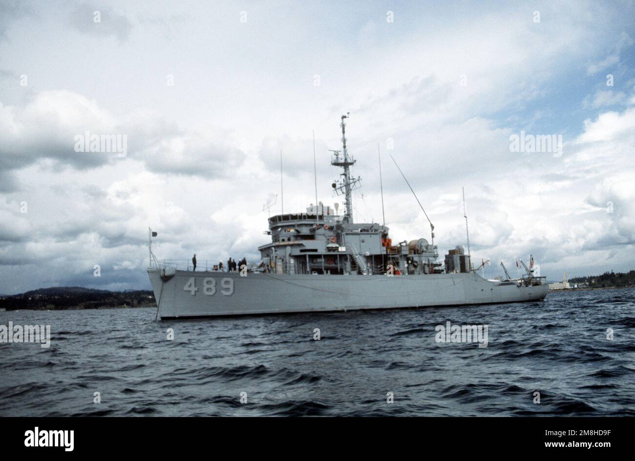 A port bow view of the ocean minesweeper USS GALLANT (MSO-489) anchored ...