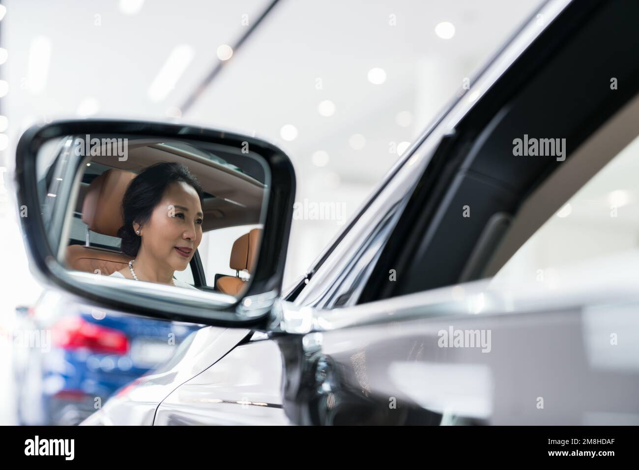 Elderly woman test drive cars Stock Photo - Alamy