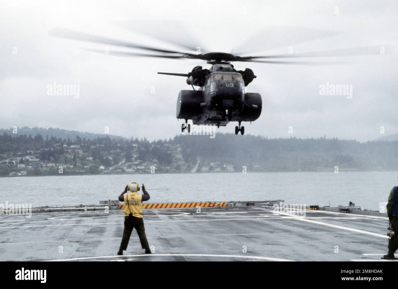 A plane director signals to the pilot of a Helicopter Mine ...