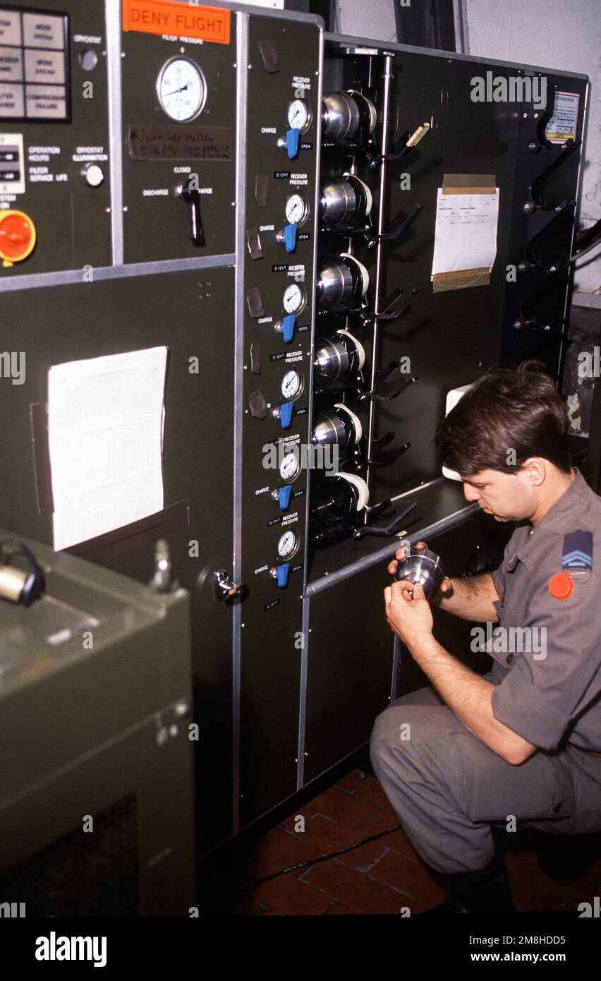 An armament technician of the Dutch air force repairs the guidance ...