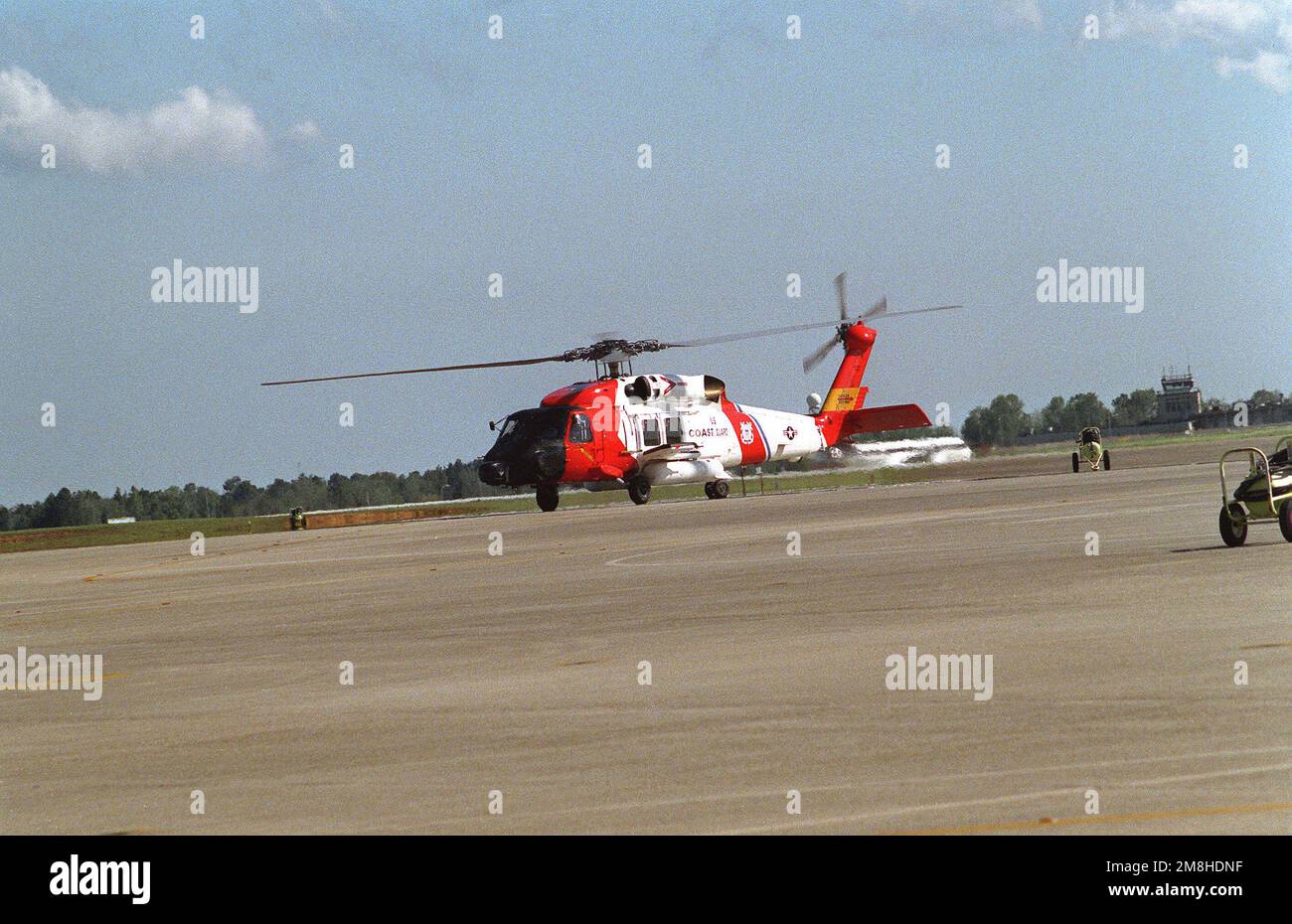 A Coast Guard HH-60J Jayhawk helicopter idles on the flight line during ...
