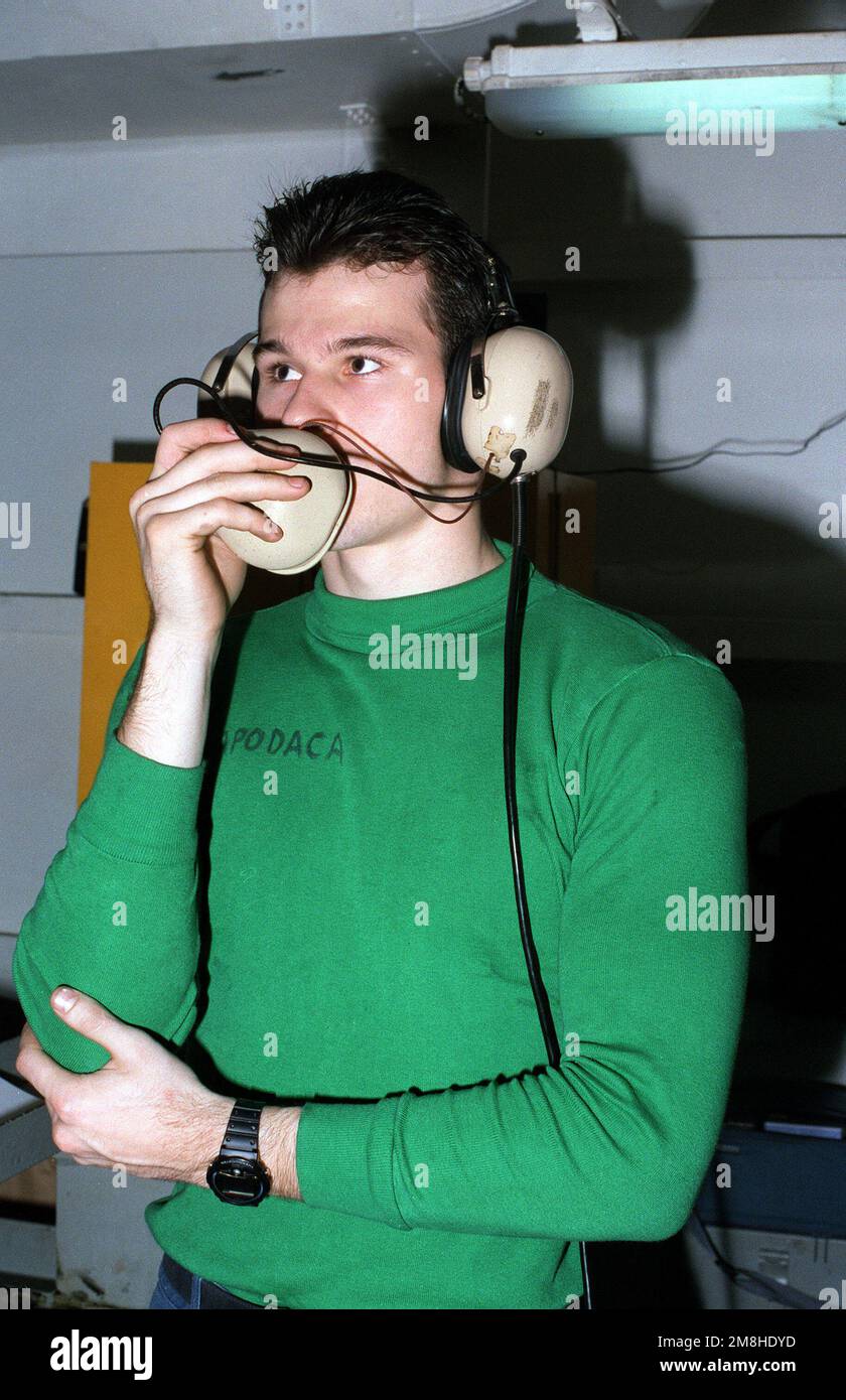 AIRMAN Steven Apodaca relays arresting gear information during flight ...