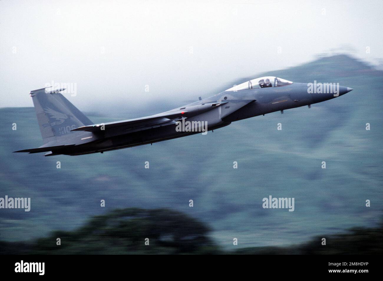 An air-to-air view of an F-15 Eagle sent to identify an aircraft which ...