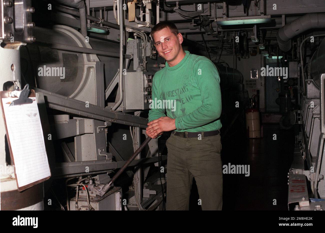 AIRMAN James M. Shuster checks the cable tension on an arresting gear ...