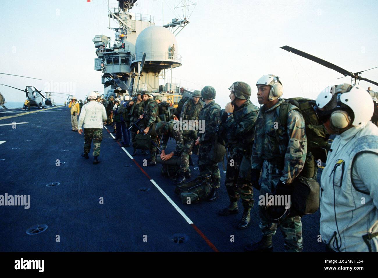 Marines line up on the flight deck of the amphibious assault ship USS ...