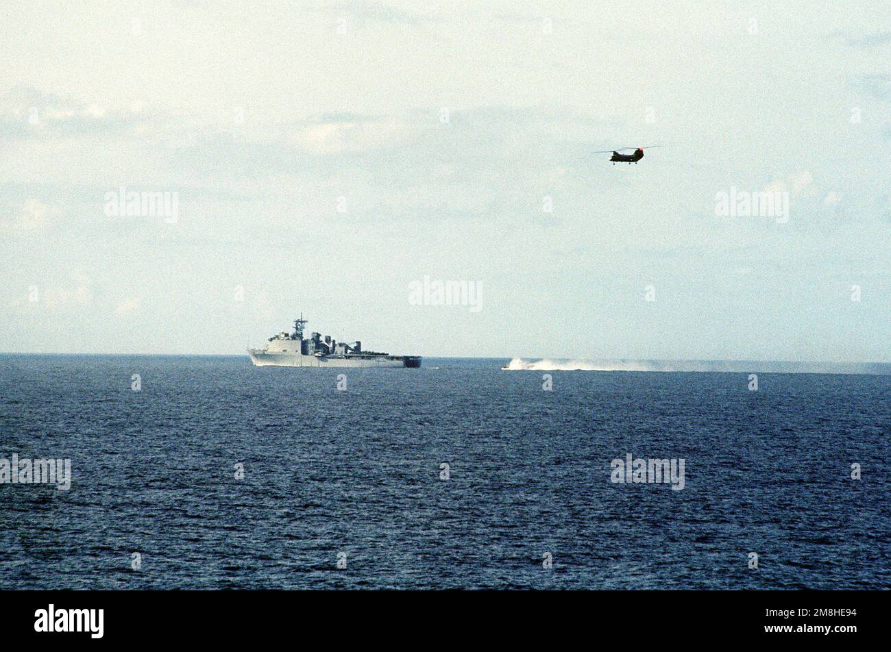 An air-cushioned landing craft (LCAC) approaches the stern of the dock ...