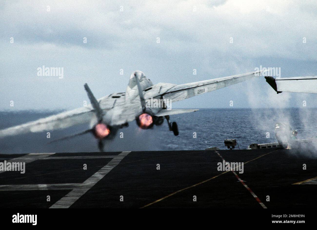 An F-14A Tomcat aircraft is launched from the aircraft carrier USS ...