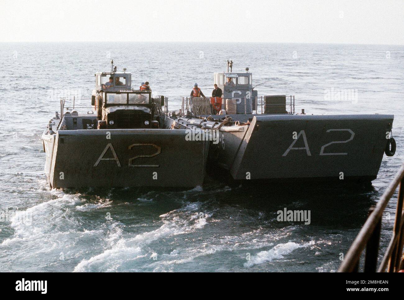 A pair of LCM-8 mechanized landing craft back away from an amphibious ...