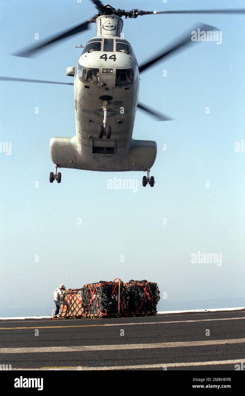 A CH-46 Sea Knight helicopter takes off after delivering a pallet of ...