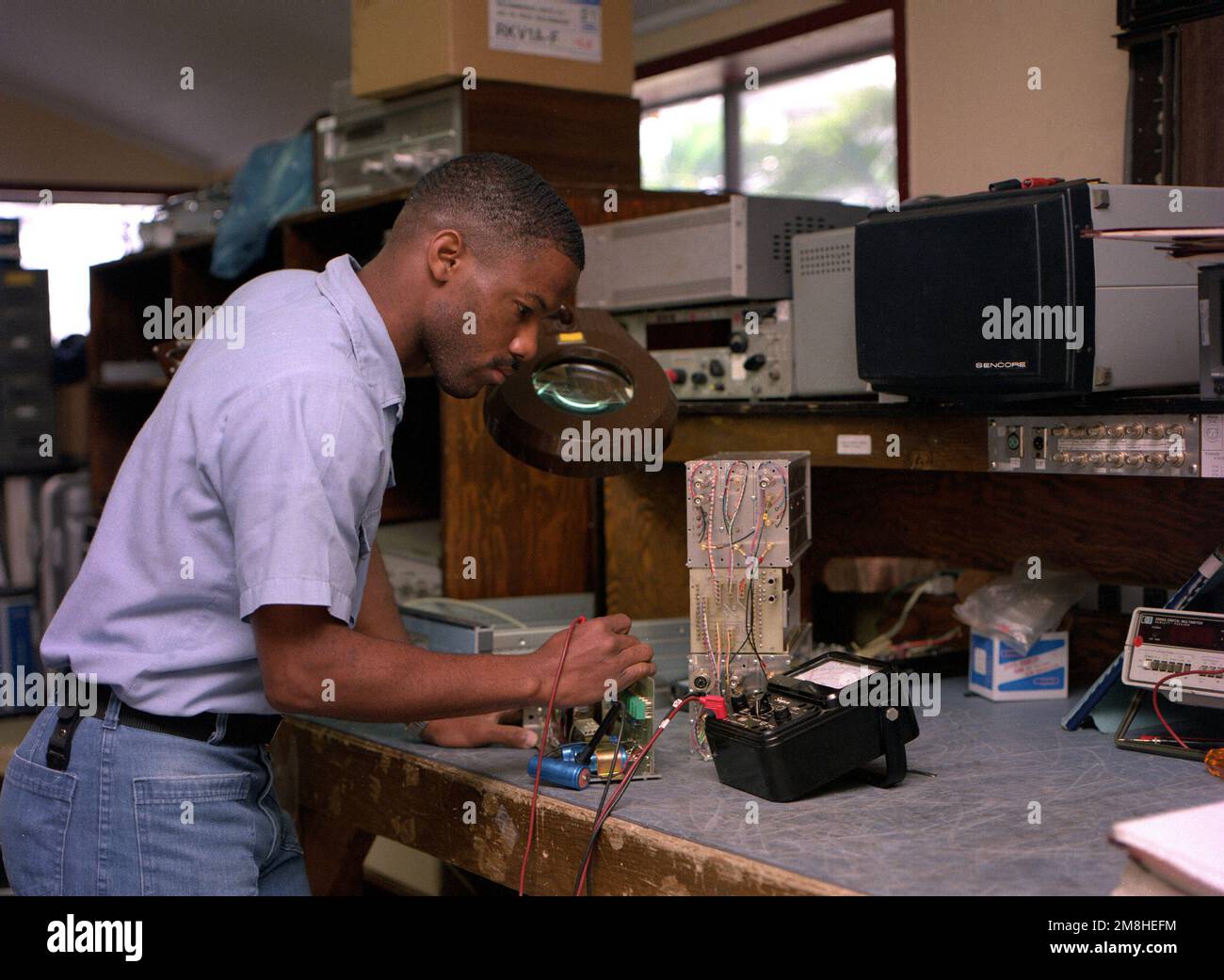 Interior Communications Electrician 2nd Class Joe L. Campbell checks ...