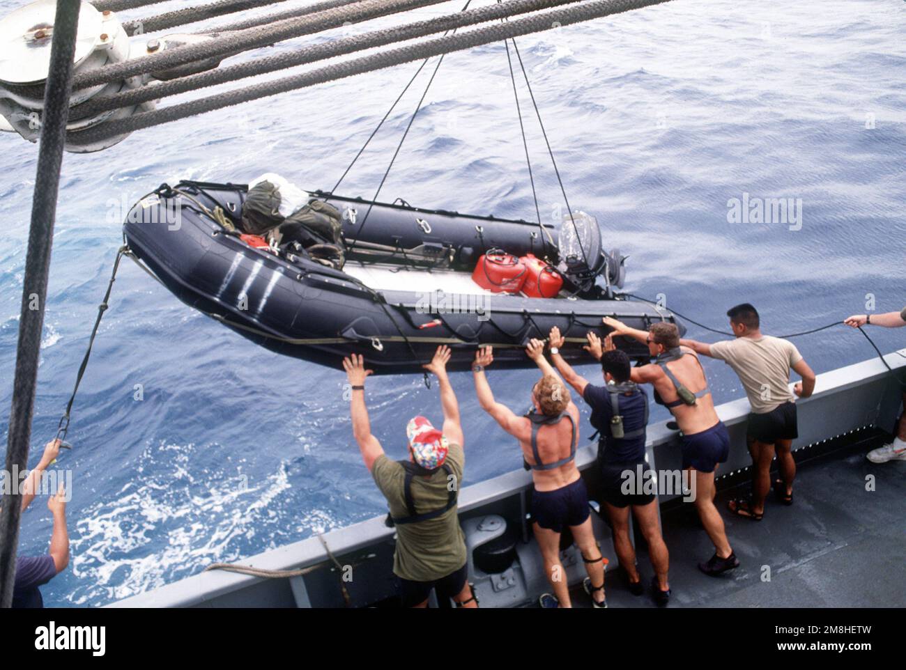 Members of Sea-Air-Land (SEAL) Team 2 launch an inflatable boat from ...